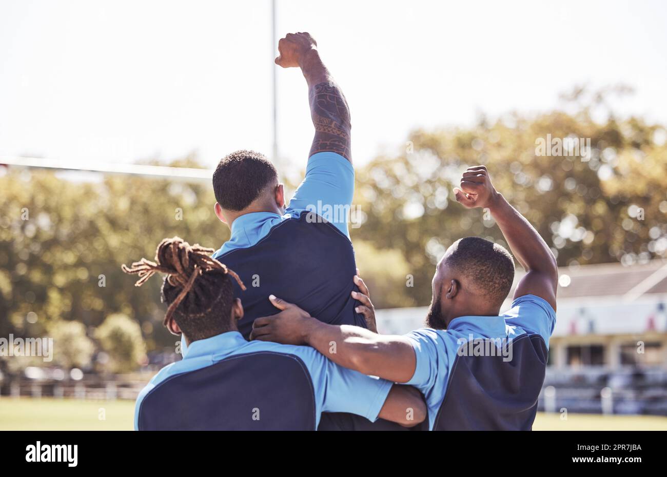 Diverse rugby teammates celebrating scoring a try or winning a match ...