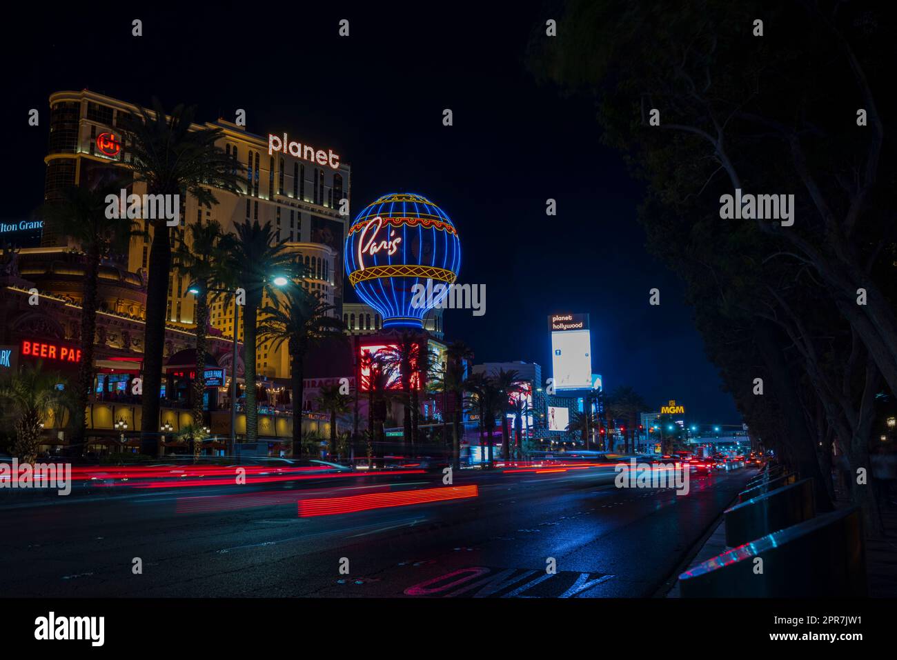Night view of Las Vegas cityscape with gorgeous defocused light tracers of cars on Strip Road ...