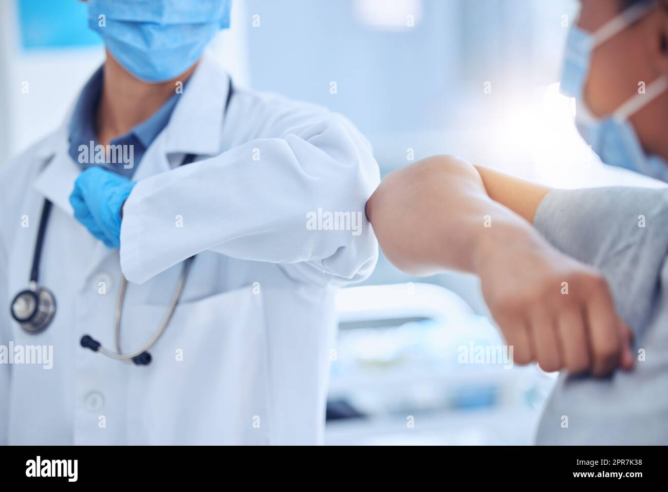Doctor and patient safely greeting each other. Doctor giving a patient ...