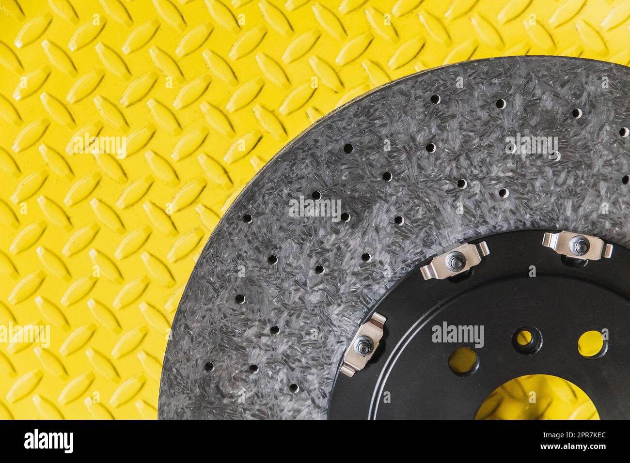 new carbon brake disc on yellow background Stock Photo - Alamy