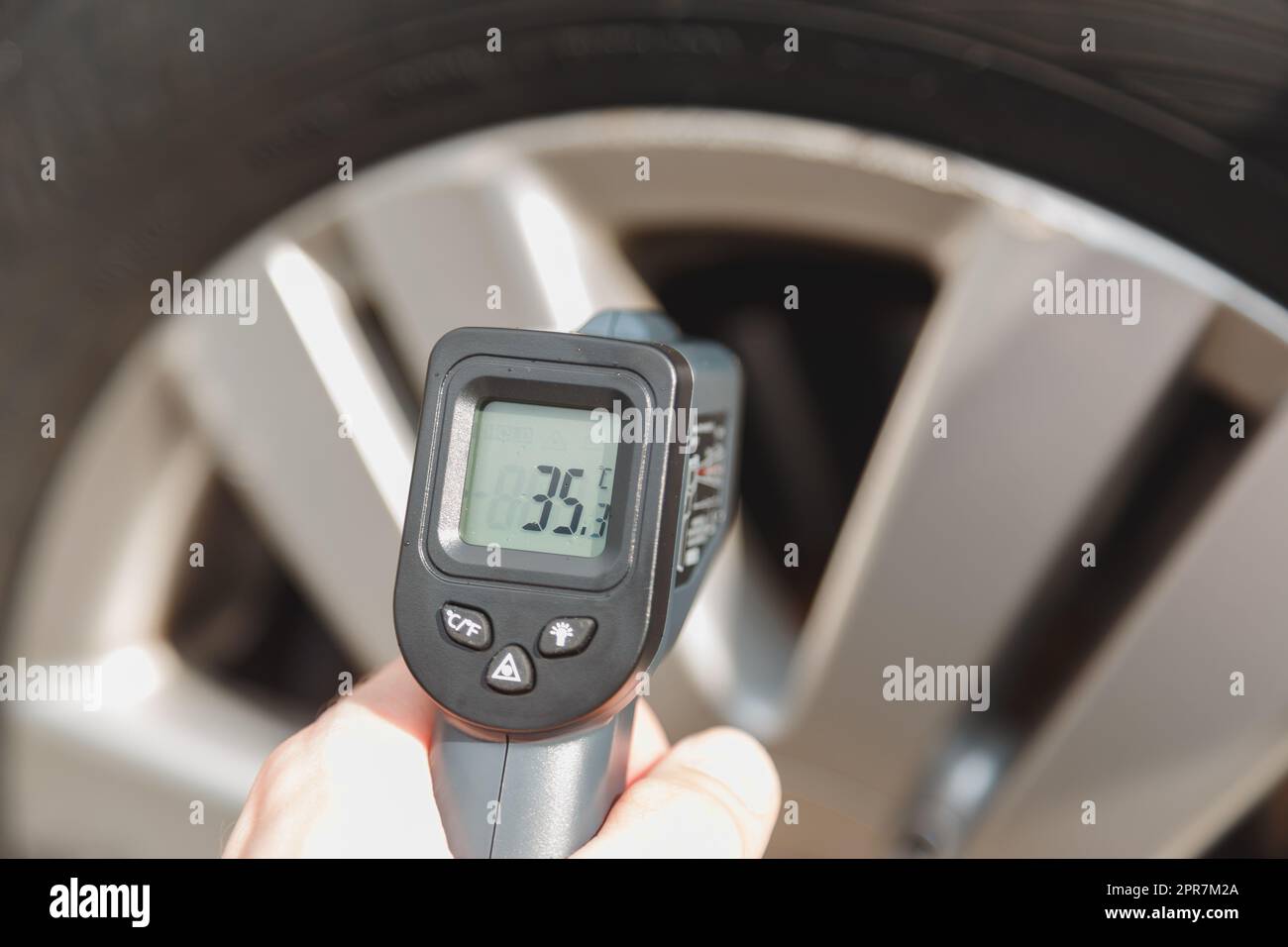 Hand of Technician Measuring of Temperature Vehicle Brake Disc with ...