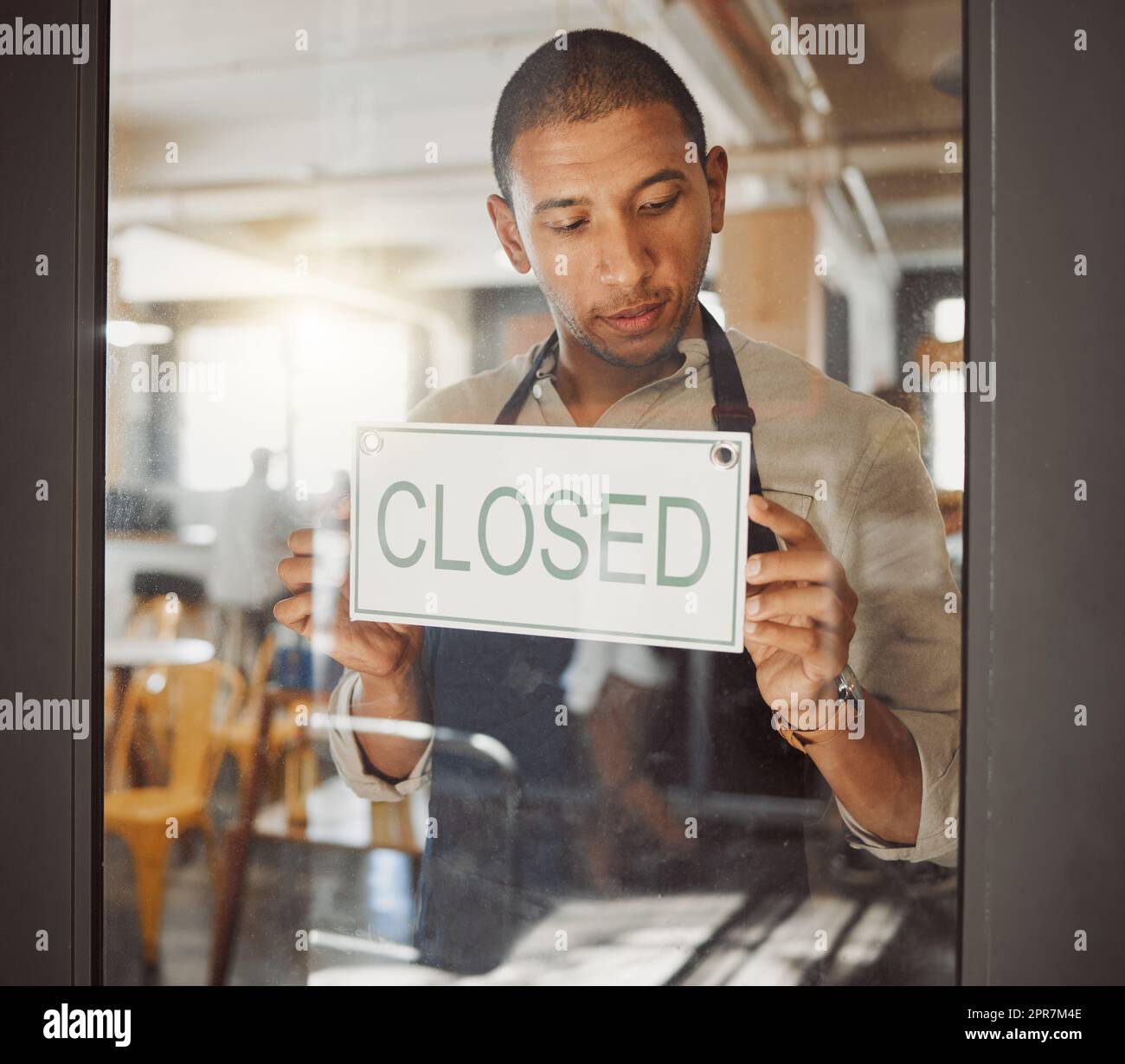 Businessman advertising that his shop is closed. Young business owner ...