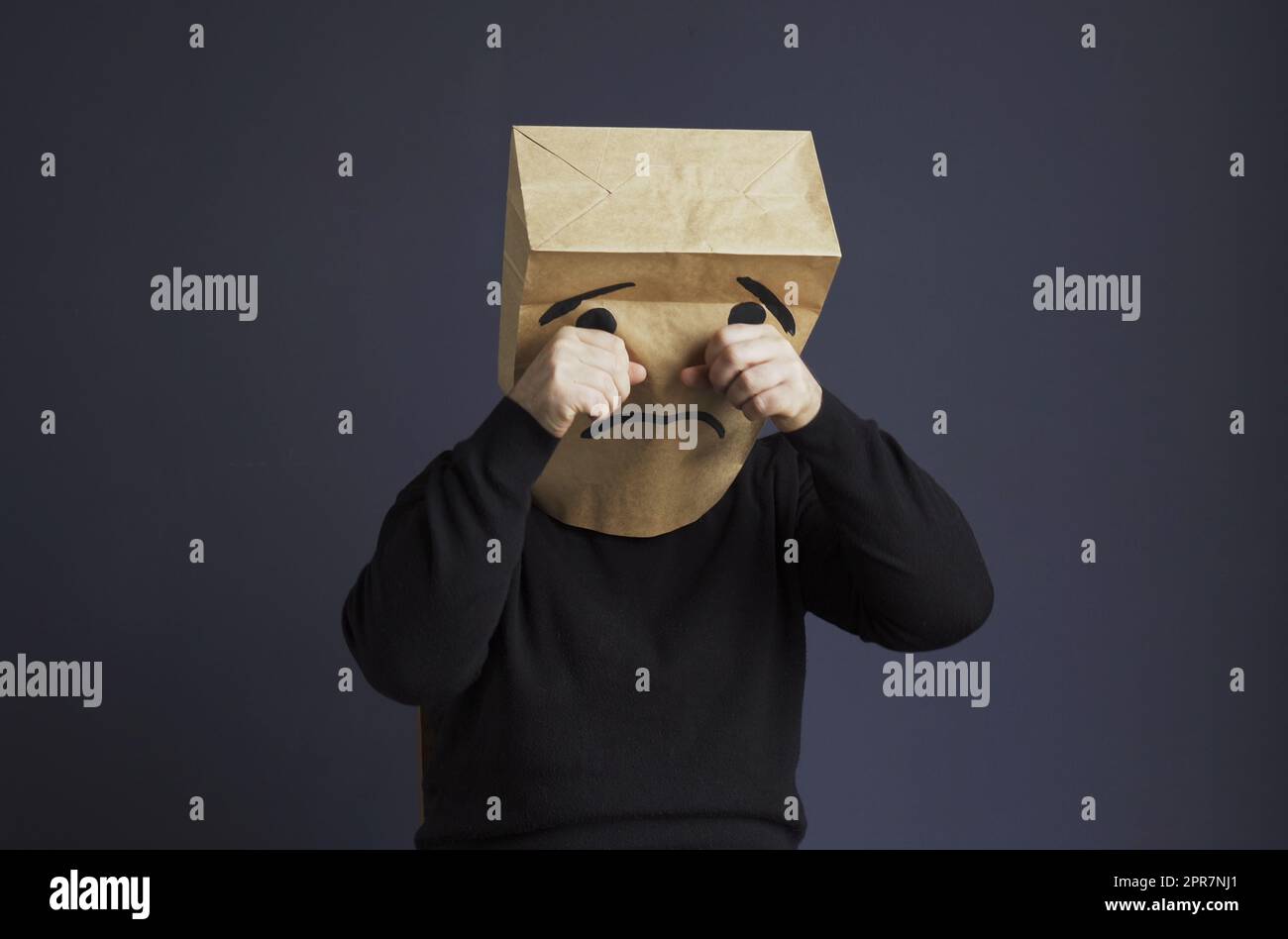 A sad man in a black turtleneck with a bag on his head, with a drawn ...