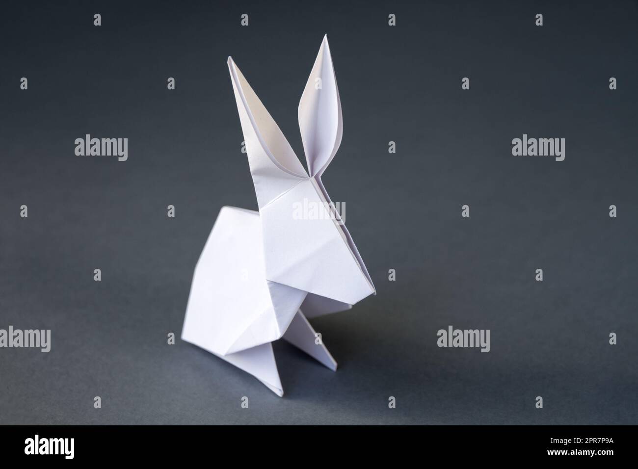 White paper rabbit origami isolated on a grey background Stock Photo ...