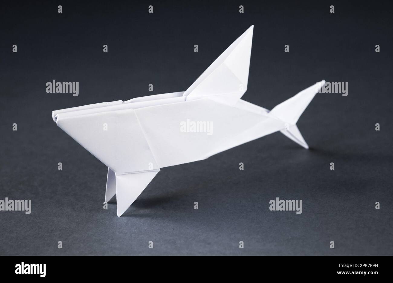 White paper shark origami isolated on a grey background Stock Photo - Alamy