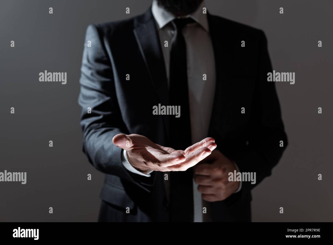 Businessman Holding Important Message On Hand. Man In Suit Presenting ...