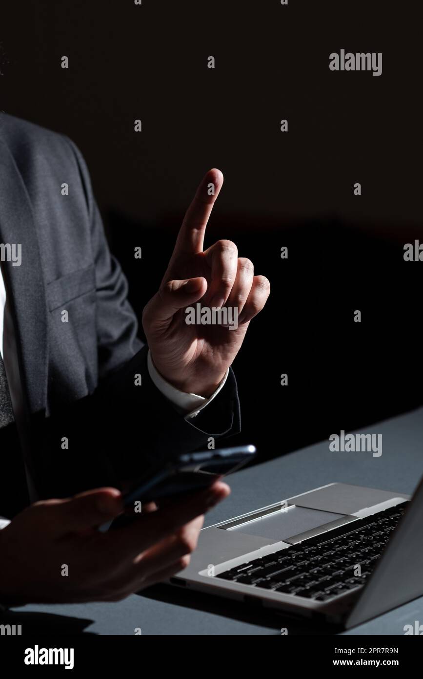 Businessman Holding Mobile Phone In Hand And Pointing With One Finger ...