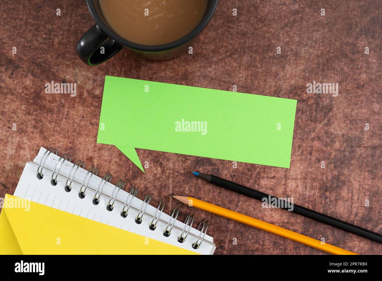 Color Speech Bubble With Spiral Notebook, Pencils And Coffee Mug Placed ...