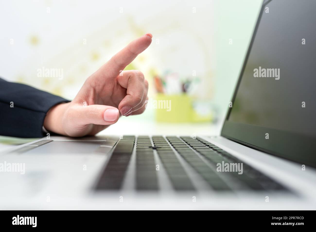 Businesswoman With Lap Top On Desk Pointing Important Messages With One ...
