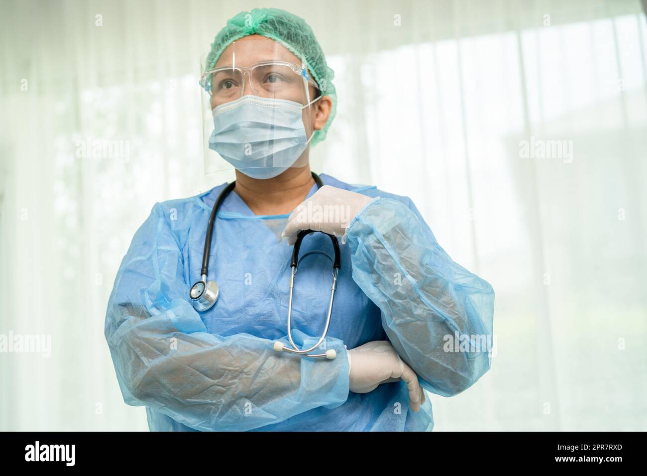 Asian doctor wearing face shield and PPE suit new normal to check ...