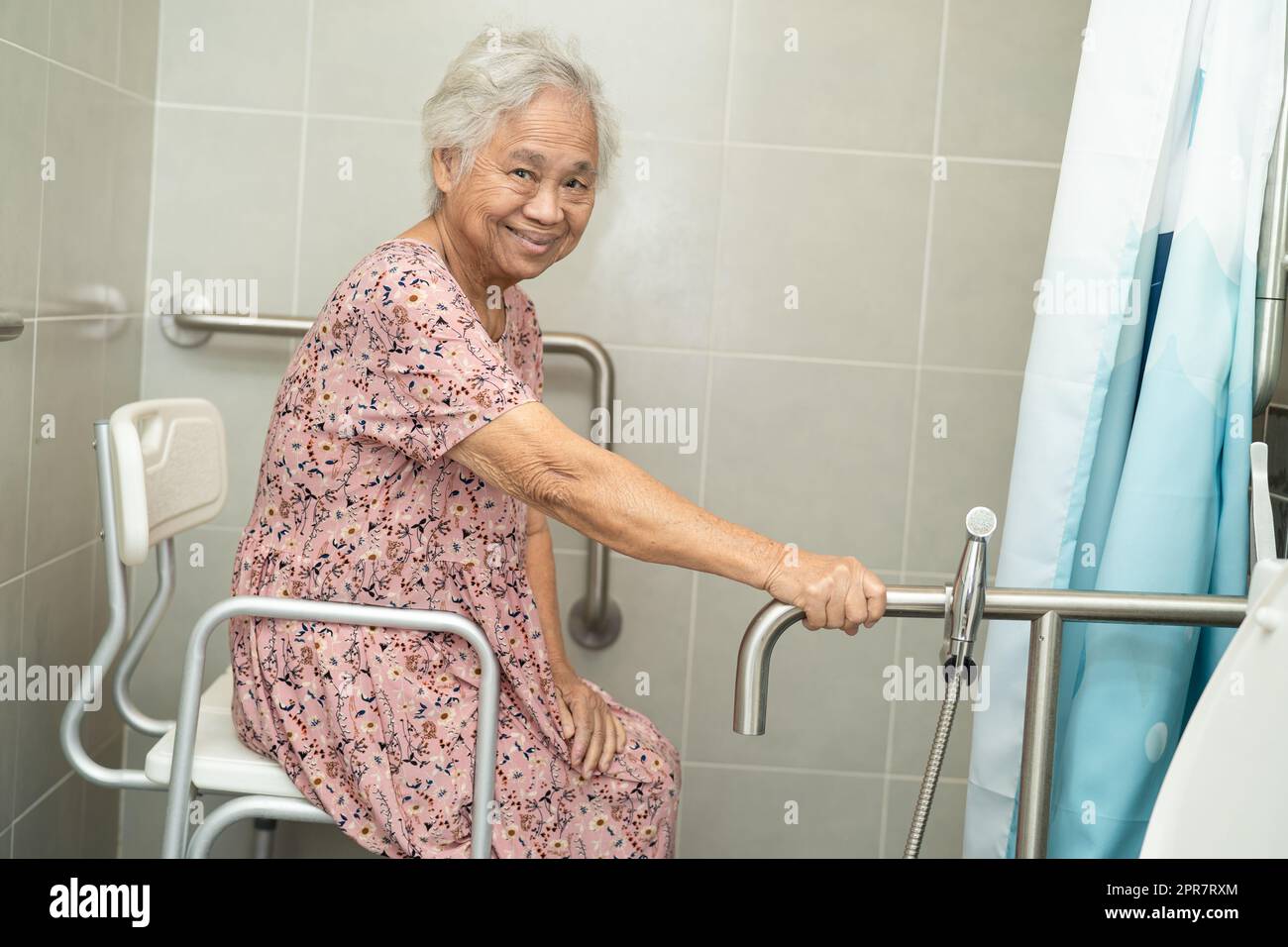Asian senior or elderly old lady woman patient use toilet bathroom ...