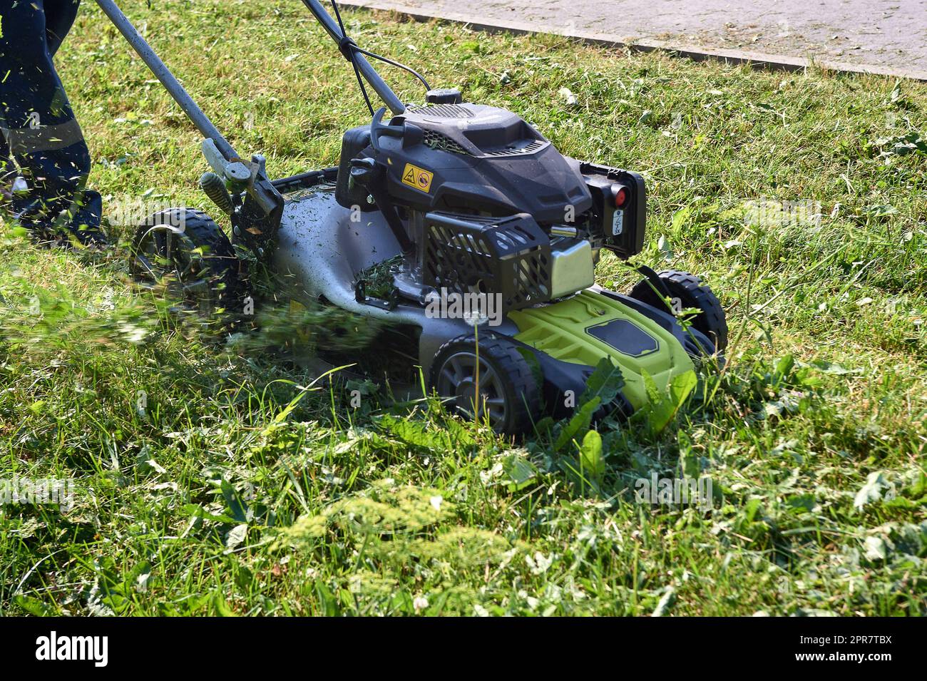lawn mowing with a lawn mower Stock Photo - Alamy