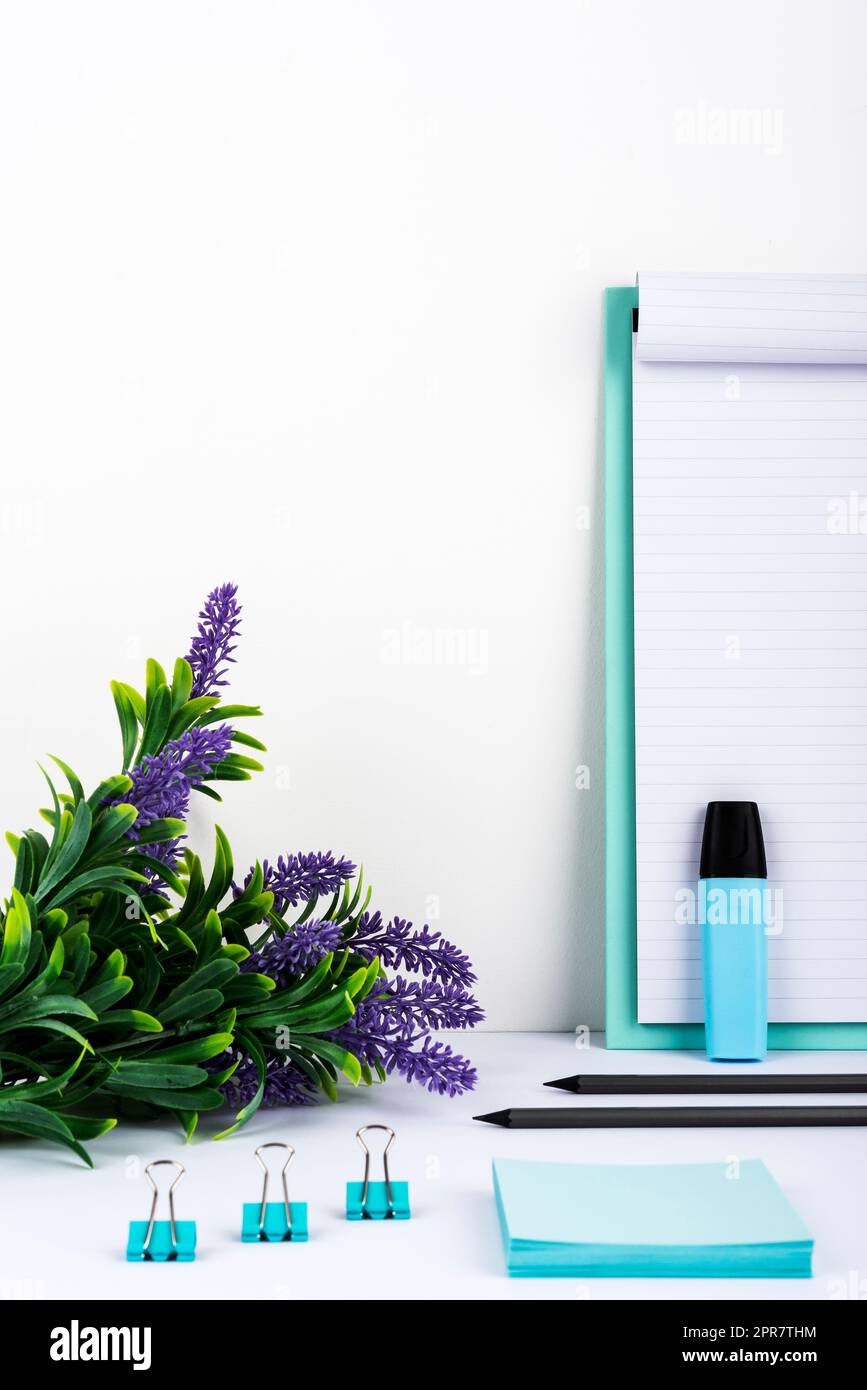 Flowers On Desk Placed Next To Clipboard With Important Message ...