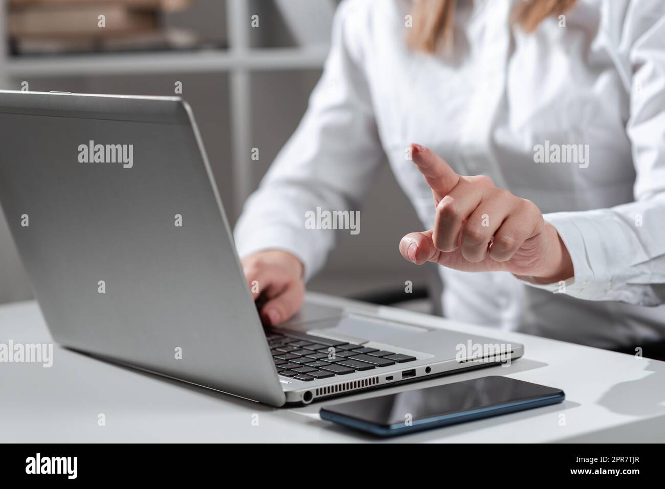 Businesswoman Typing Recent Updates On Lap Top Keyboard On Desk With ...