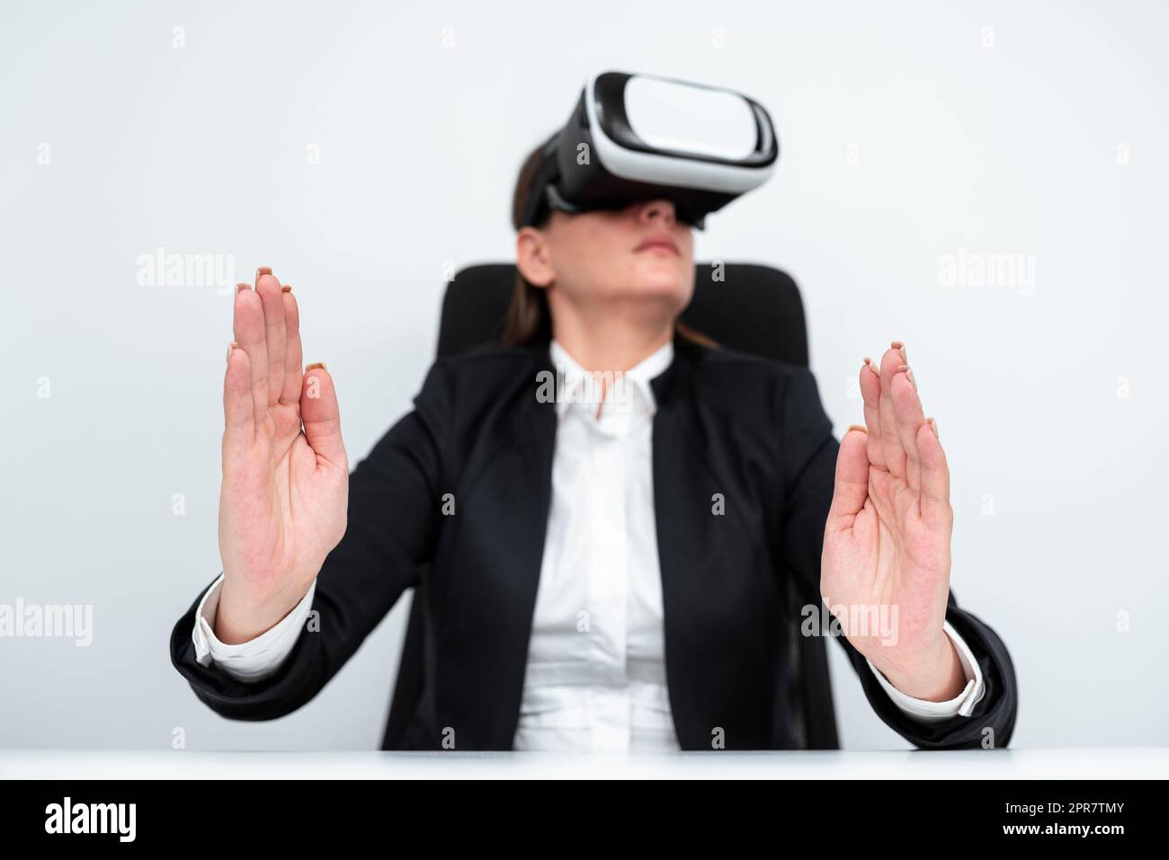 Female Executive Wearing Virtual Reality Simulator Gesturing During ...