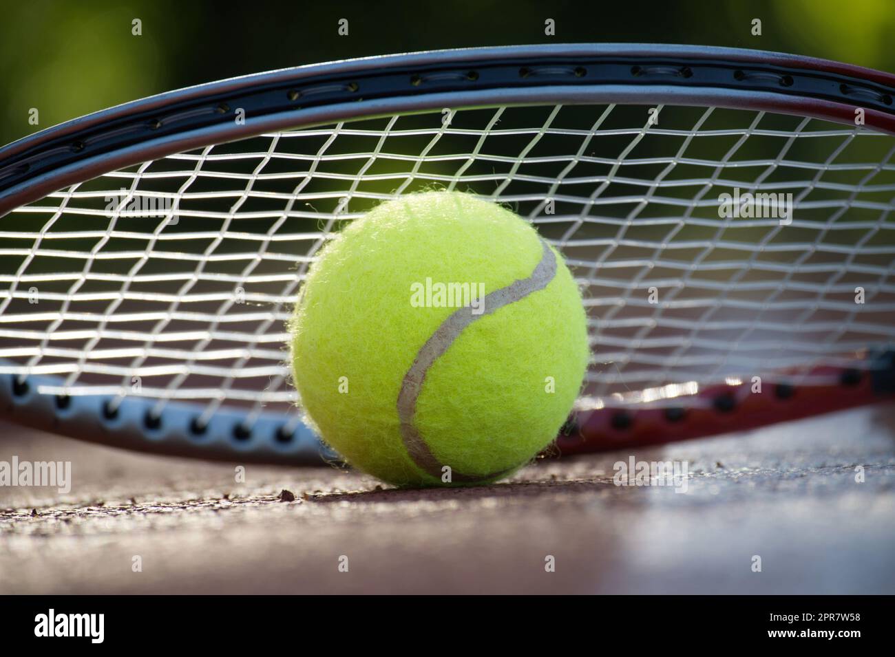 Tennis rocket over tennis ball in low angle view Stock Photo - Alamy