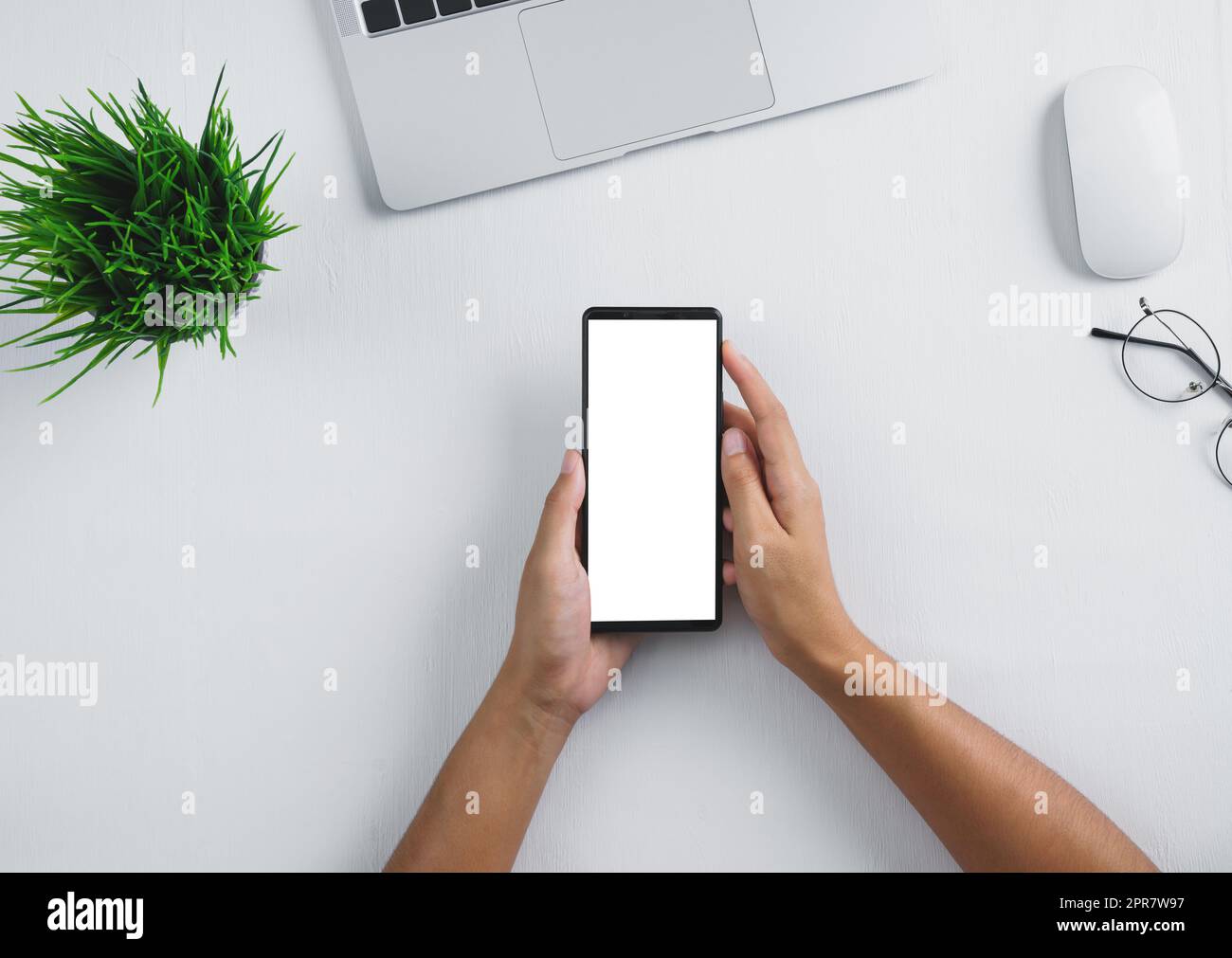 phone mobile white screen in hand on white table Stock Photo - Alamy