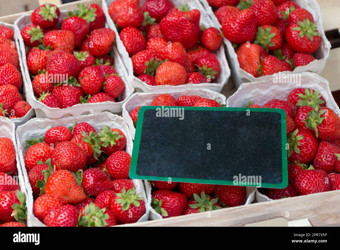 Red strawberries market baskets and black blank copyspace sign Stock ...