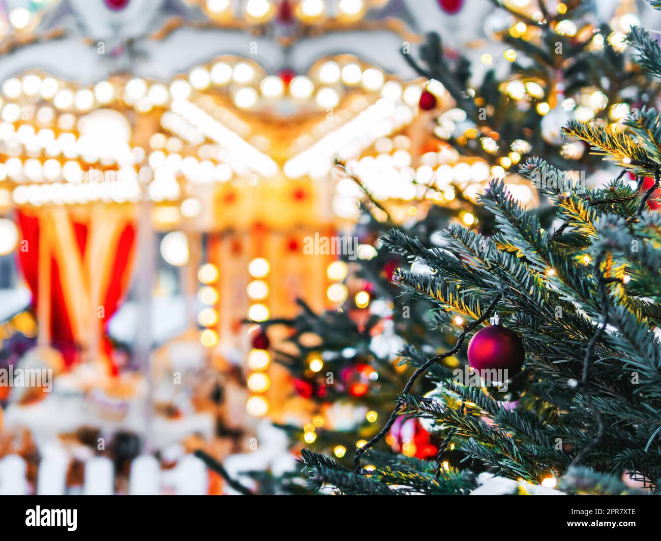 Christmas tree, blurred carousel merry go round Stock Photo - Alamy