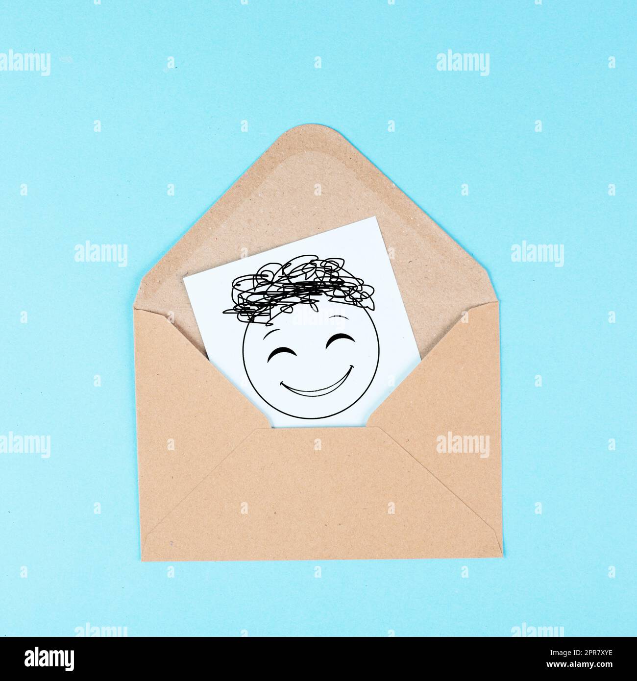 Smiling happy face on a paper inside an envelope, positive emotions ...