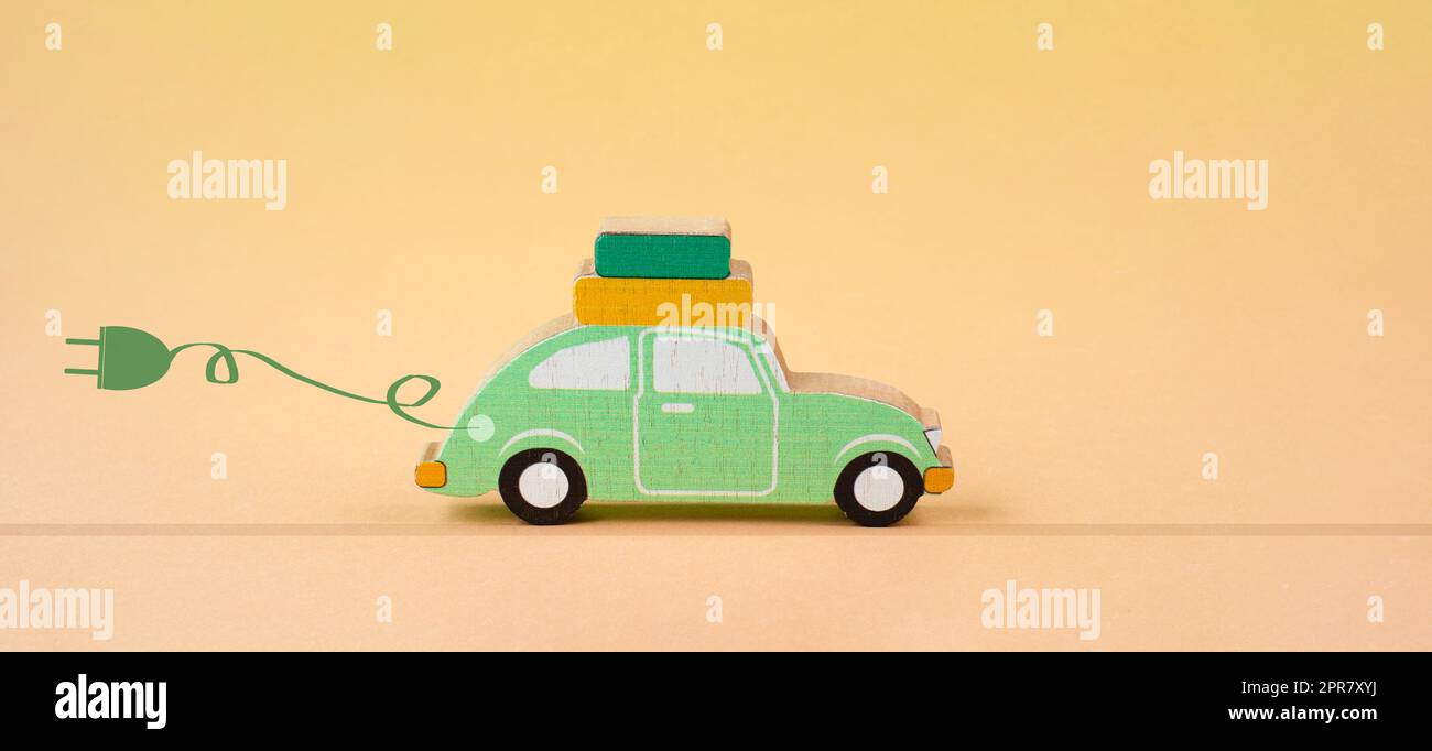 Small blue electric car with a cable for recharging, vacation trip with ...