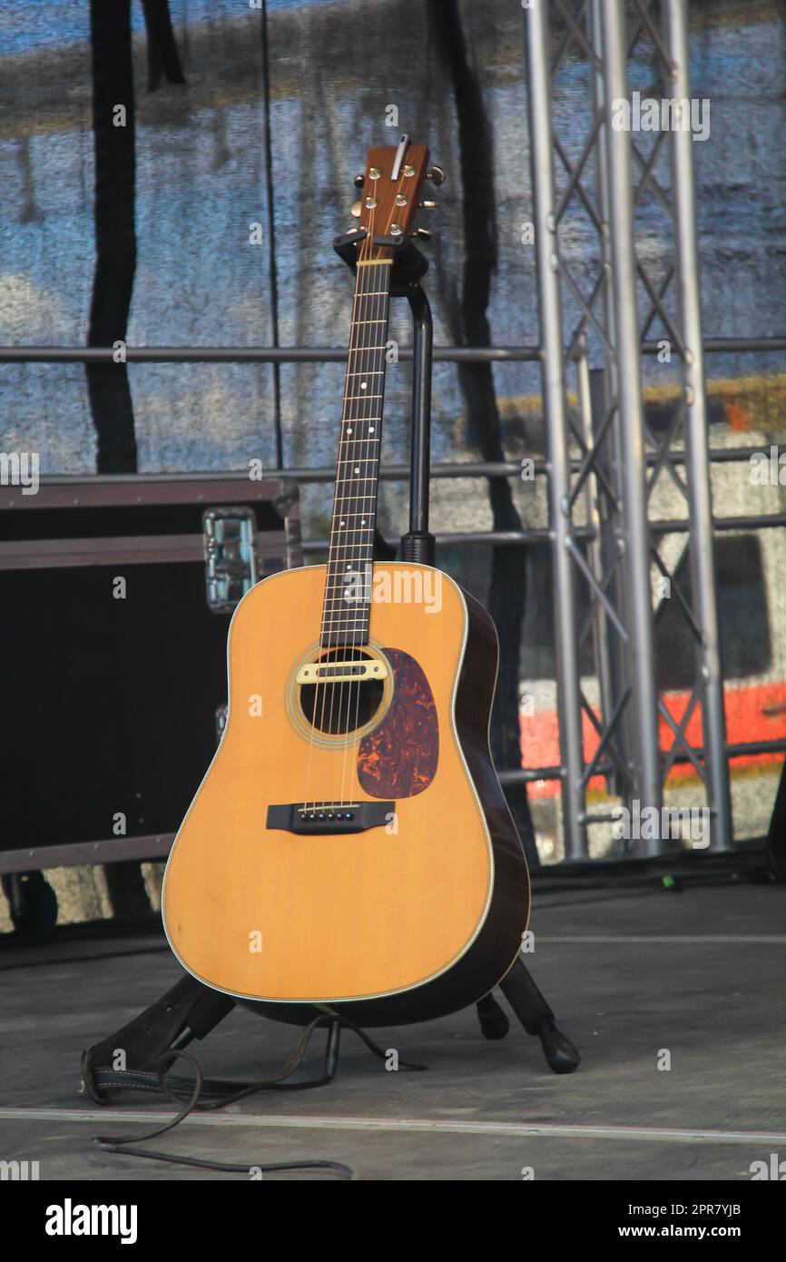 On a stage there is a guitar in a guitar stand ready for use Stock ...
