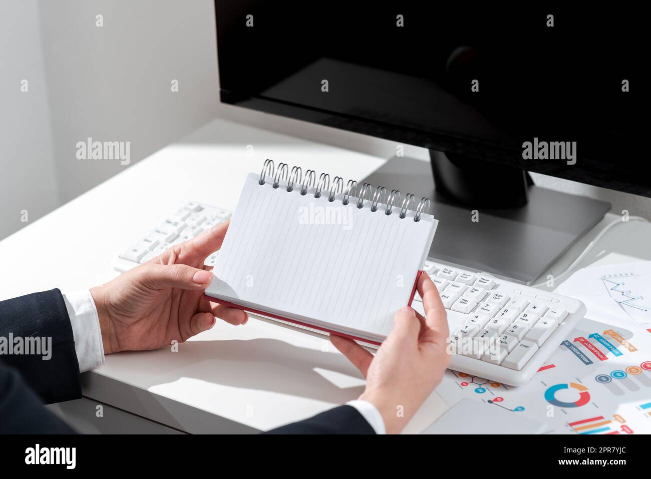 Businesswoman Holding Notebook With New Ideas Over Desk With Computer ...