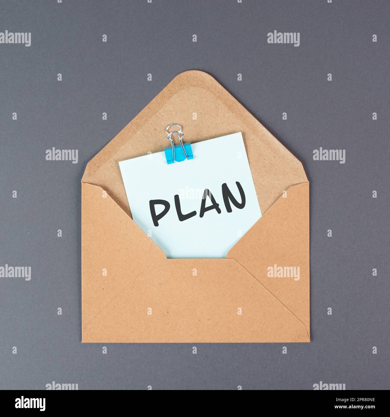 Paper with the word plan inside an envelope, planning new goals for the ...