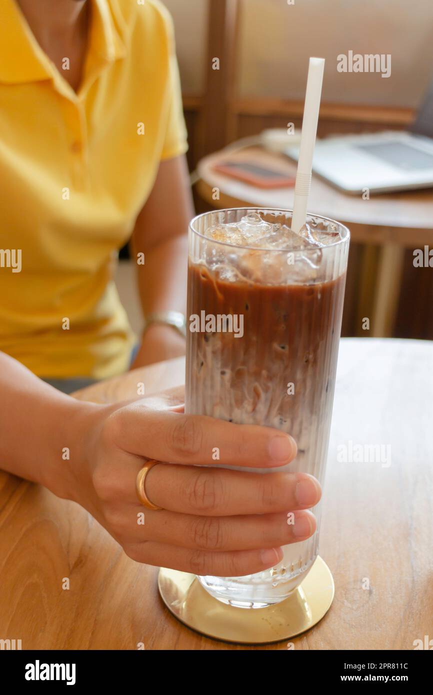 Hand on glass of iced coffee Stock Photo - Alamy