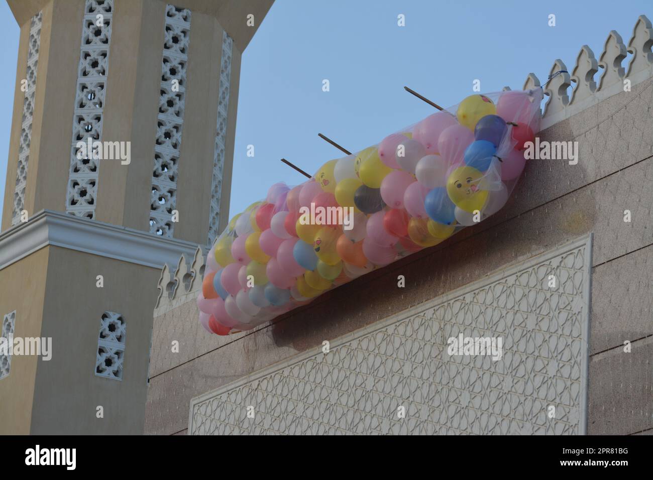 Background of festive and celebrations outside a mosque in Cairo Egypt with tens of balloons ...