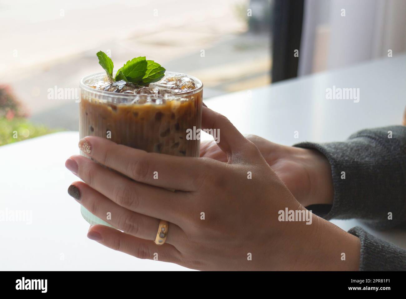 Hand on glass of iced coffee Stock Photo - Alamy