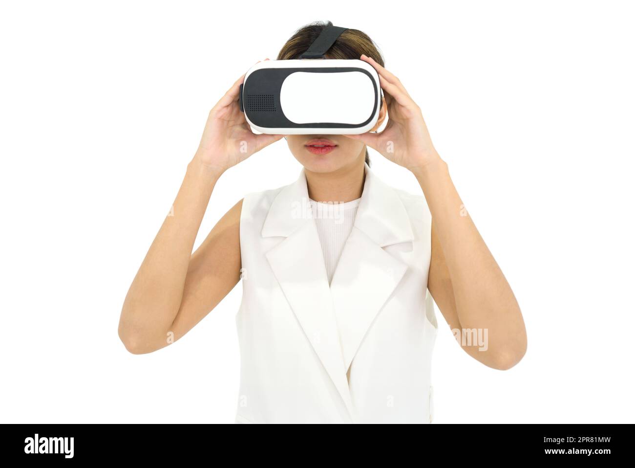 Asian woman in white dress using virtual reality glasses, play an interactive game. Future ...