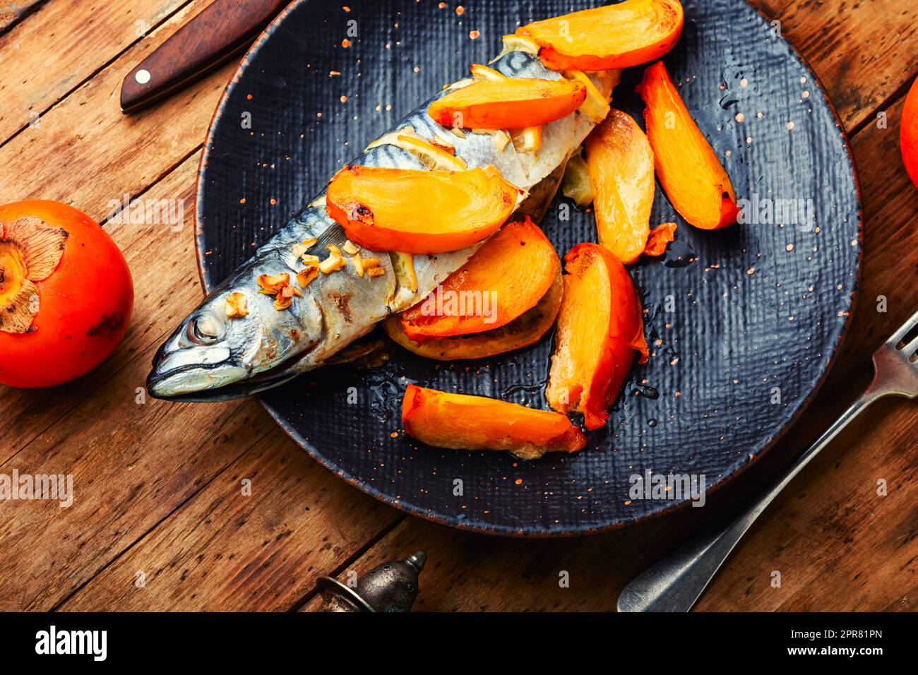 Baked fish with persimmon Stock Photo - Alamy