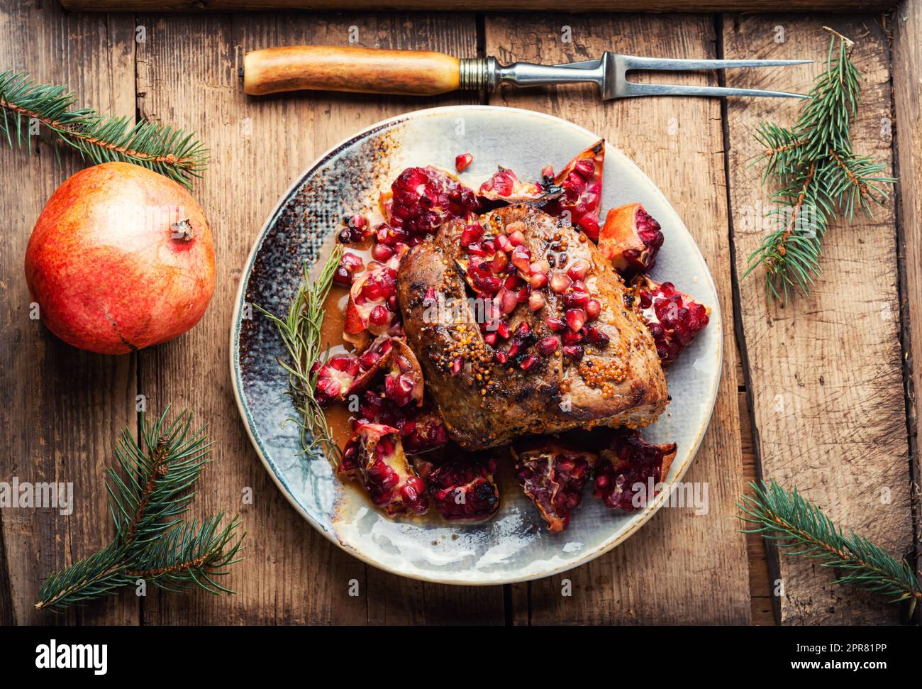Pork meat fried with pomegranate Stock Photo - Alamy