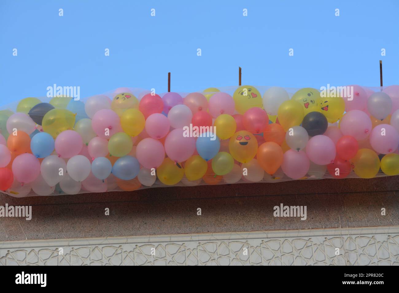 Background of festive and celebrations outside a mosque in Cairo Egypt with tens of balloons ...