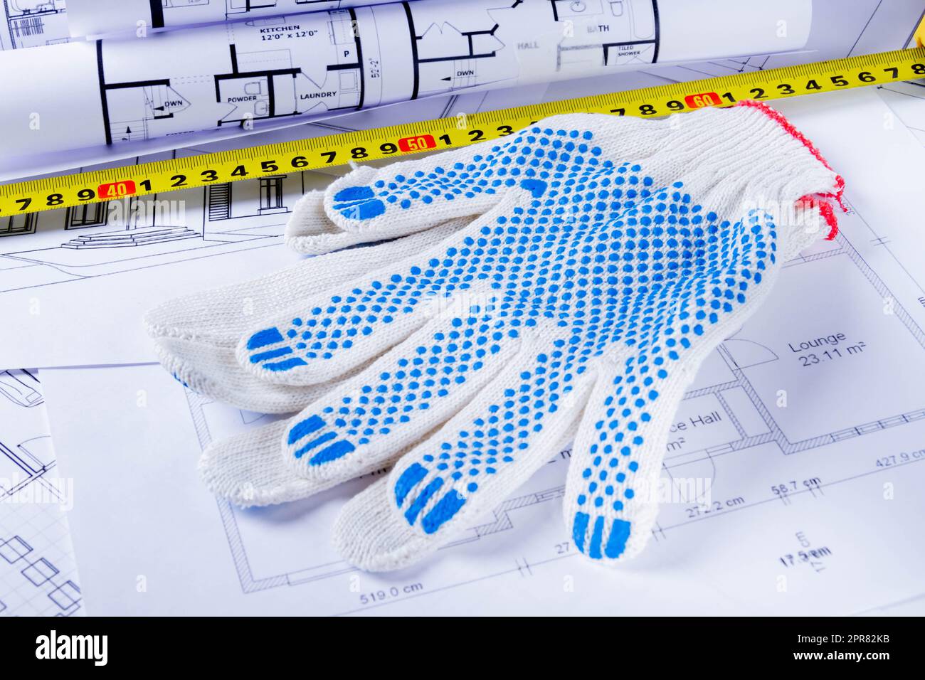 Builder's tools on the scheme of the house. Preparing to build a house ...