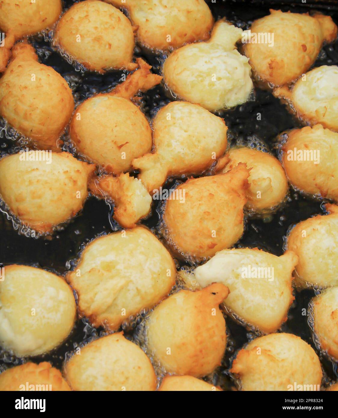 A whole lot of curd balls in a boiling oil bath Stock Photo - Alamy