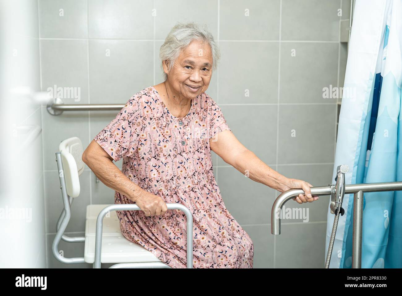 Asian senior or elderly old lady woman patient use toilet bathroom ...