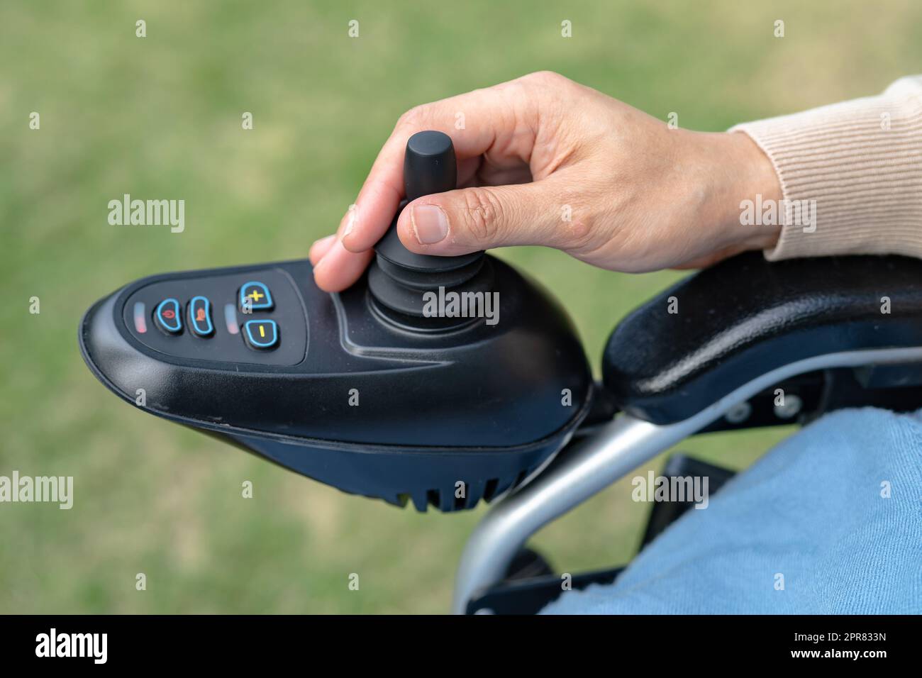Asian lady woman patient on electric wheelchair with joystick and ...