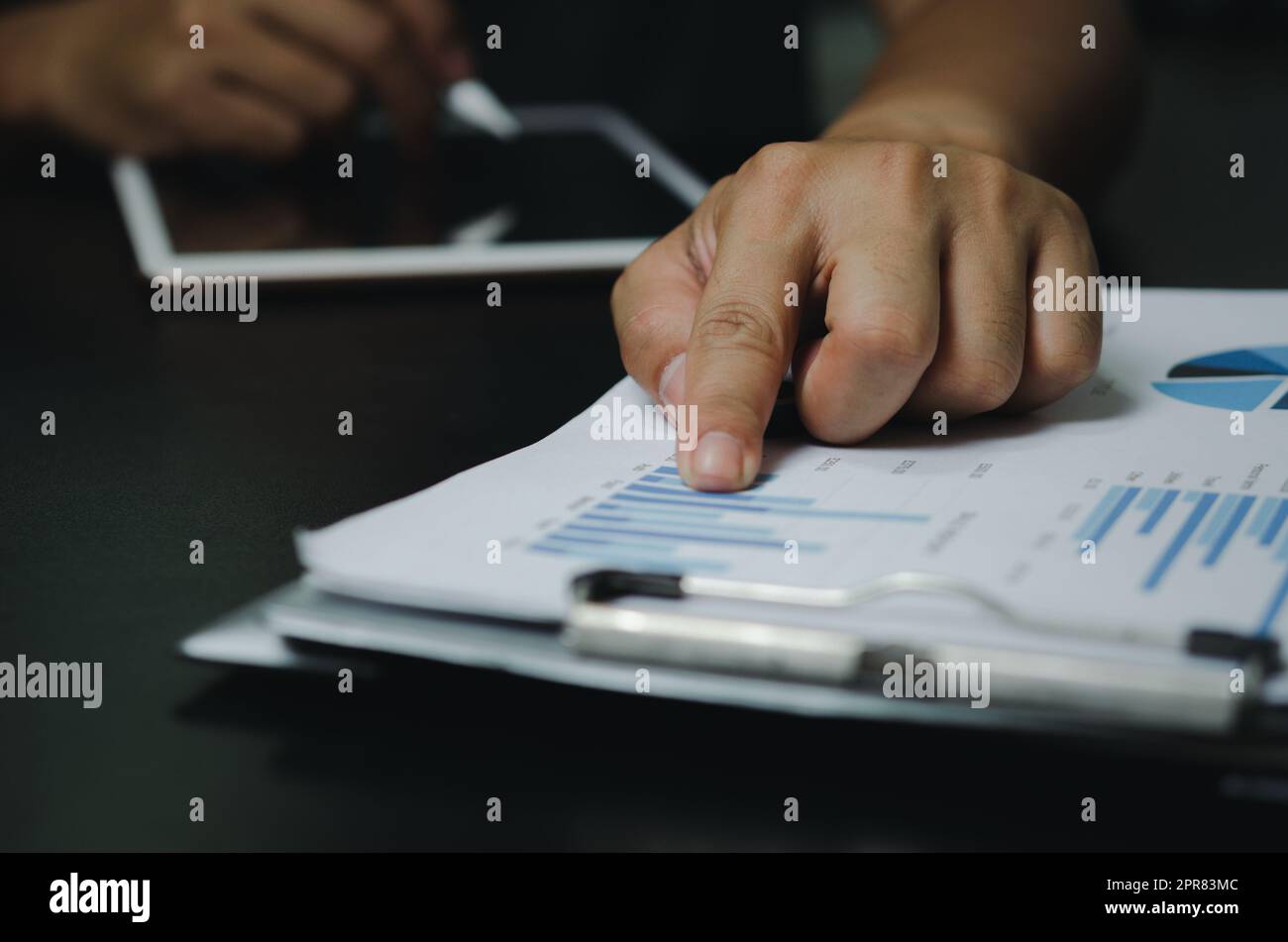 Man hand pointing document graph and chart project business finance and ...