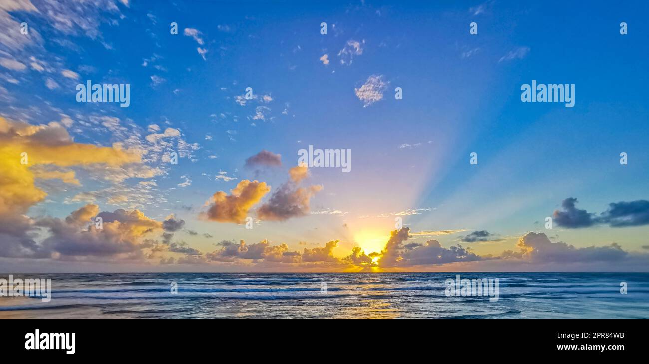 Golden colorful sunrise sunset with sunbeams tropical beach Tulum ...
