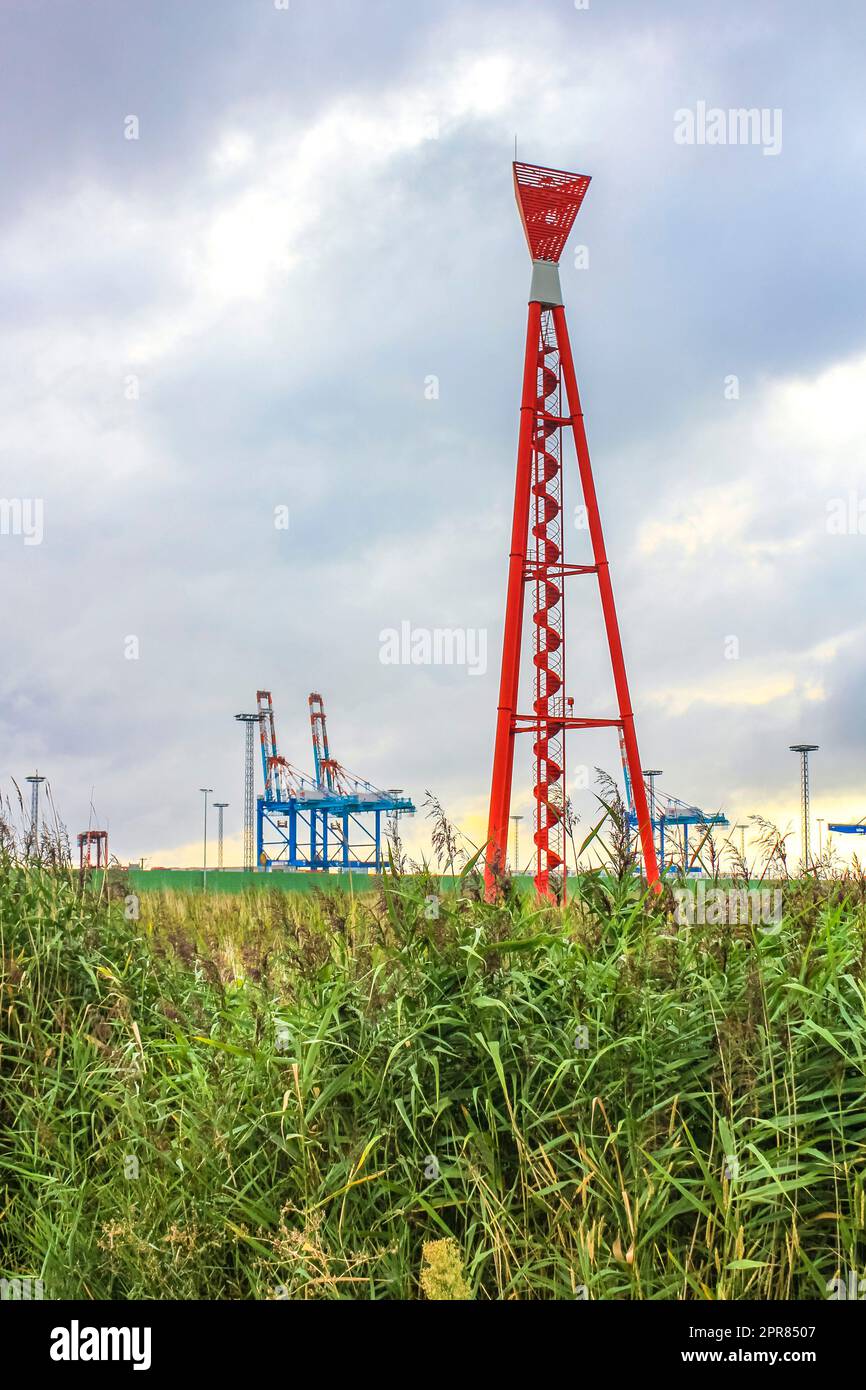Industrial area cranes red tower lighthouse dyke seascape panorama ...