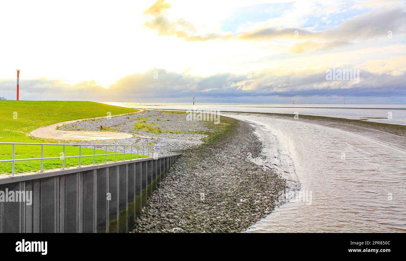 Industrial area cranes red tower lighthouse dyke seascape panorama ...