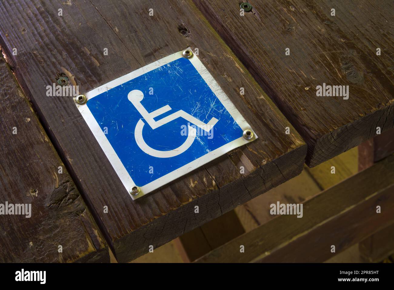 handicap sign wheelchair accessibility metal blue pictogram on wood ...