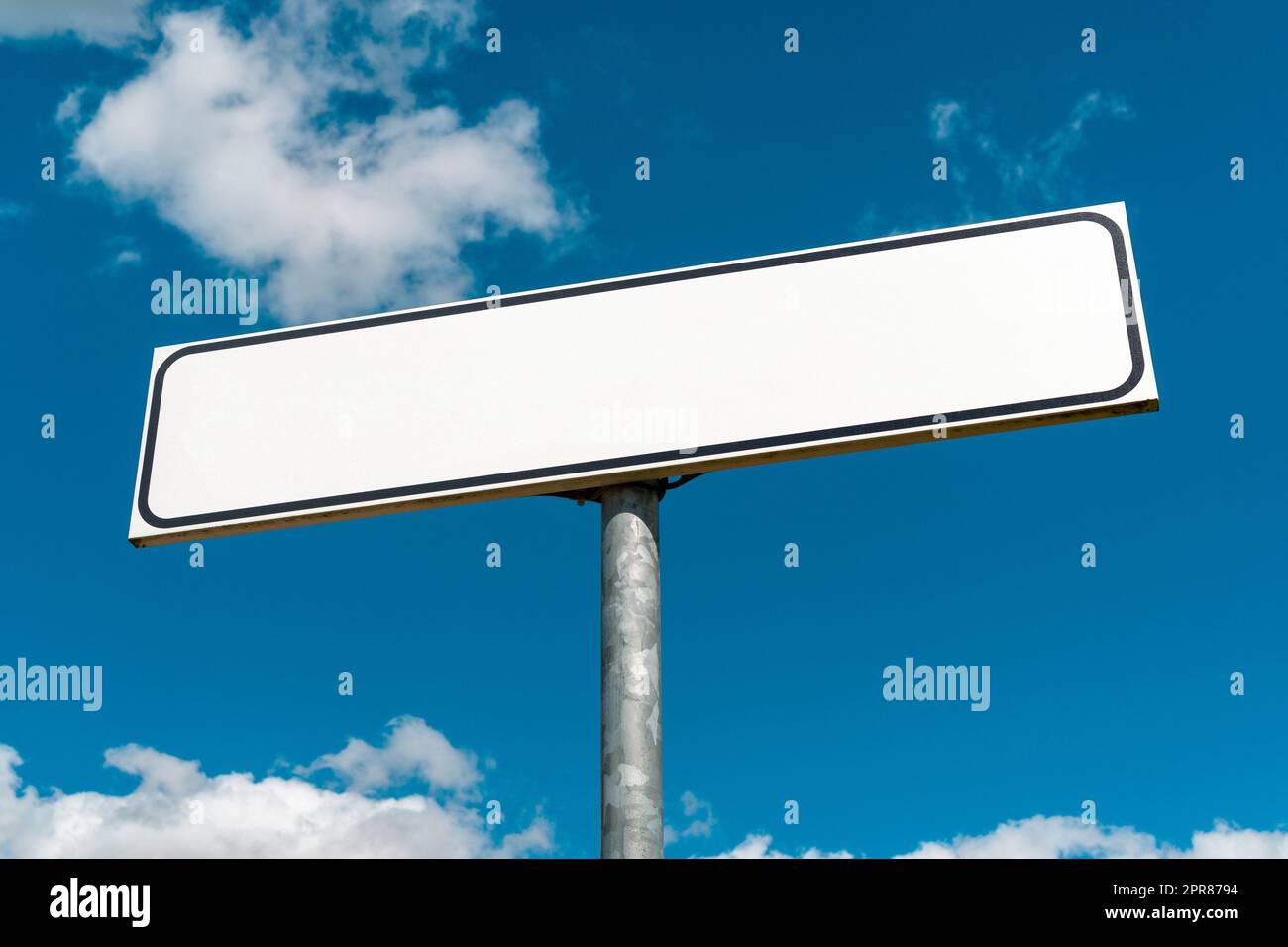 Blank white road sign on sky background Stock Photo - Alamy