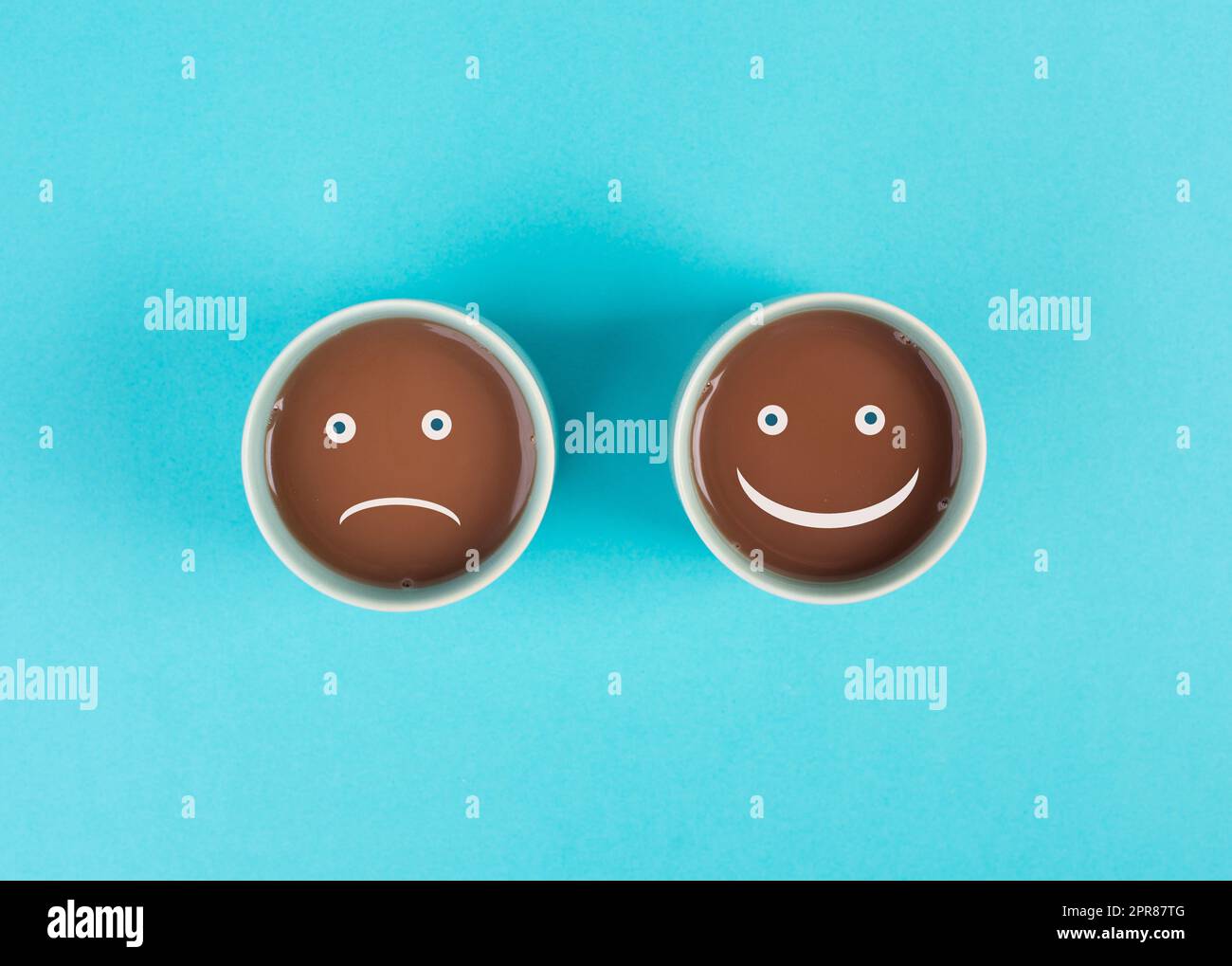 Cup of coffee with a sad and a happy face, positive and negative ...