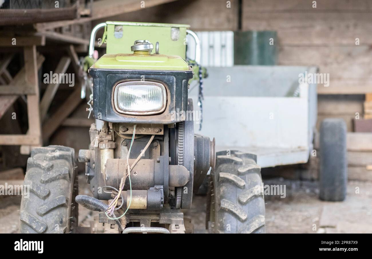 Typical heavy diesel walking tractor with trailer. Agricultural ...