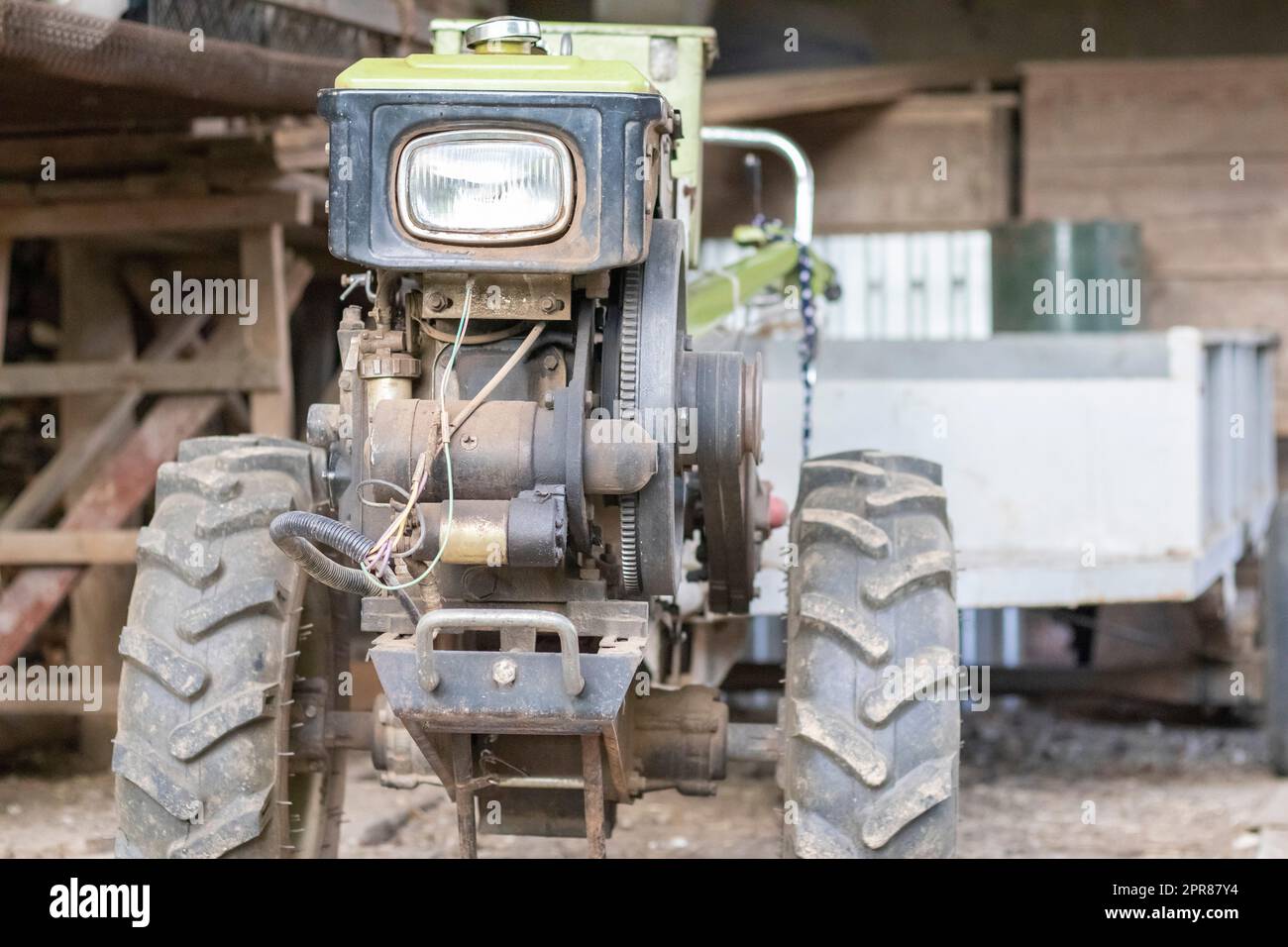 Typical heavy diesel walking tractor with trailer. Agricultural ...