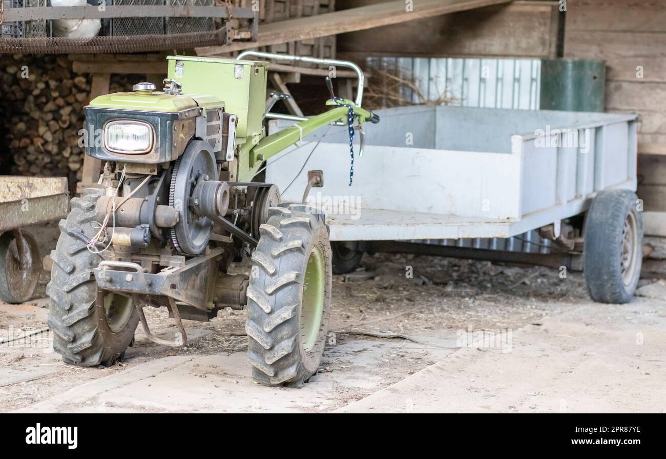 Typical heavy diesel walking tractor with trailer. Agricultural ...