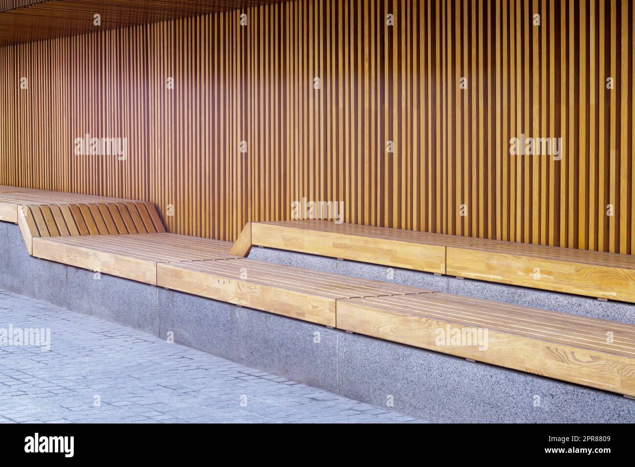 Empty modern wooden benches without people on a sunny day, public ...